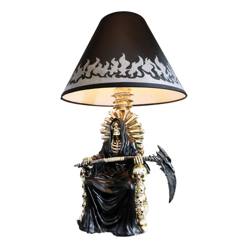 The scary wise grim reaper holding a scythe sitting on a desk lamp